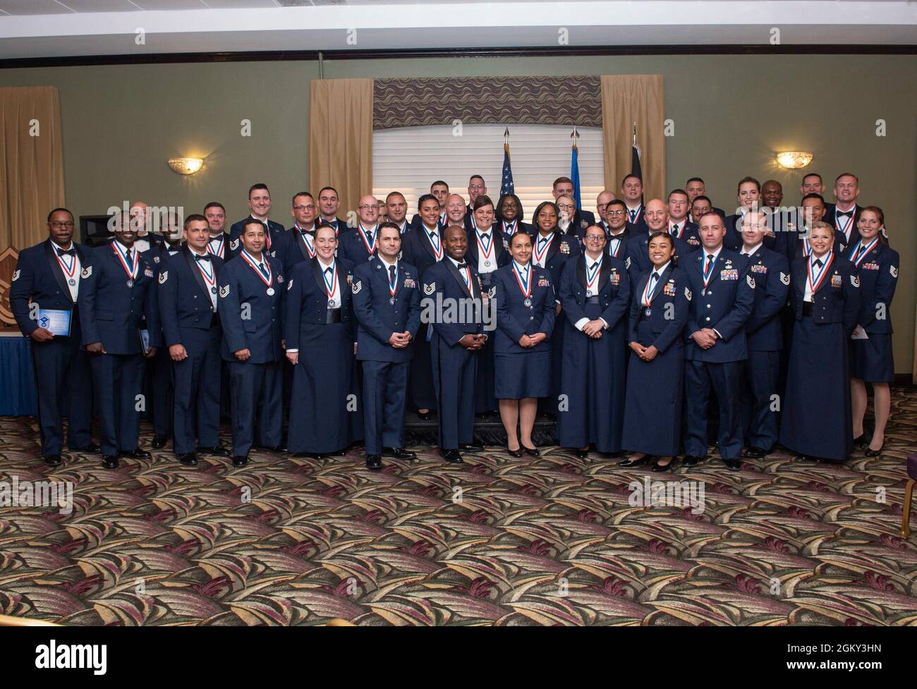 Promotees pose for a photo with Col. Patrick Miller, 88th Air Base Wing ...