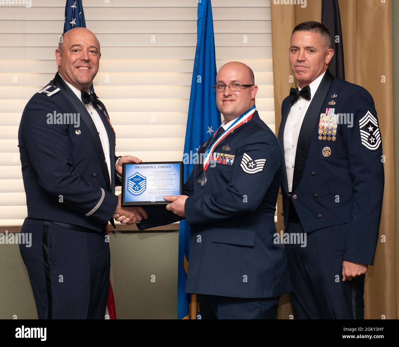 A promotee poses for a photo with Col. Patrick Miller, 88th Air Base ...