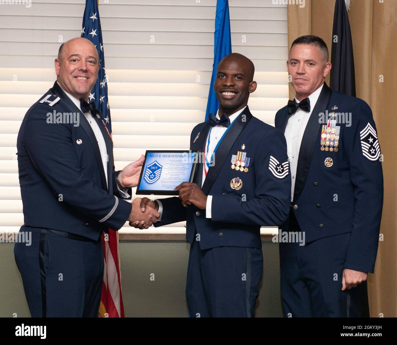 A promotee poses for a photo with Col. Patrick Miller, 88th Air Base ...