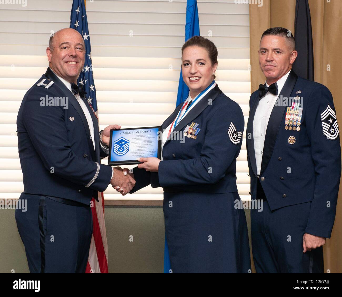 A promotee poses for a photo with Col. Patrick Miller, 88th Air Base ...