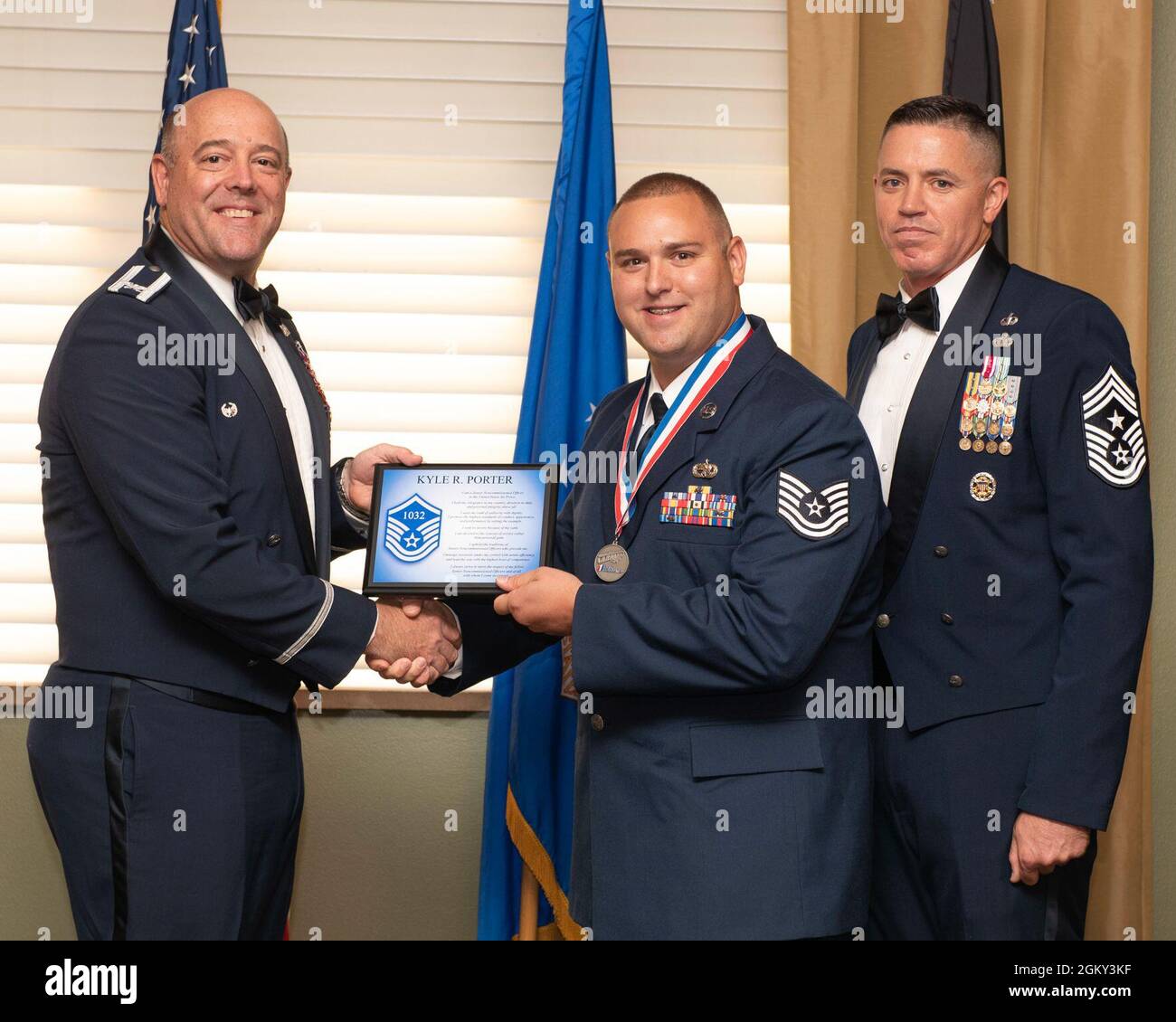 A promotee poses for a photo with Col. Patrick Miller, 88th Air Base ...