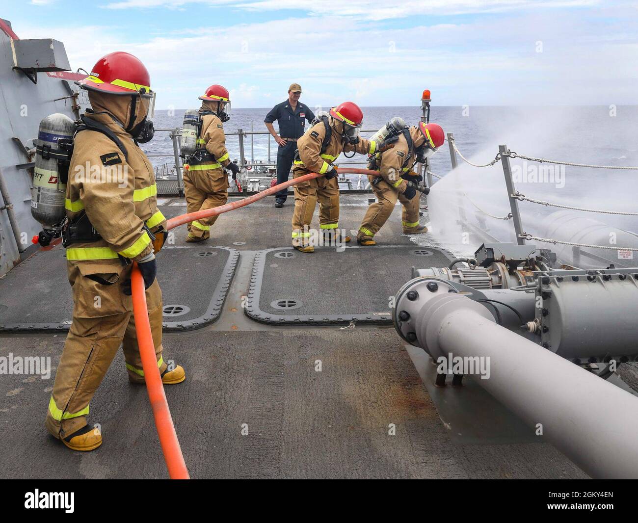 Sailors simulate fighting a fire with a charged hose during a ...