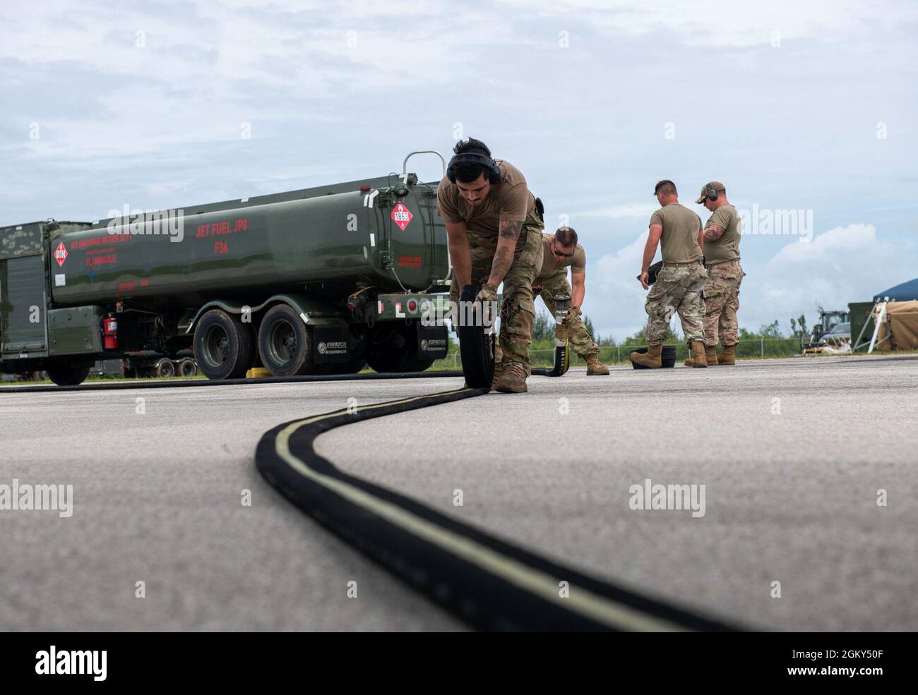 U.S. Air Force Airmen roll up fuel hoses July 25, 2021, at Tinian ...