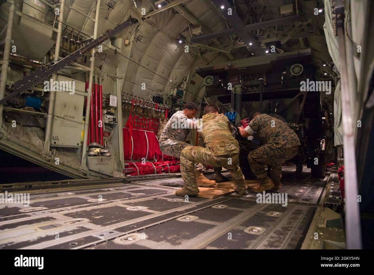 U.S. Marines and Airmen unload an AN/TPS-80 Ground/Air Task Oriented ...