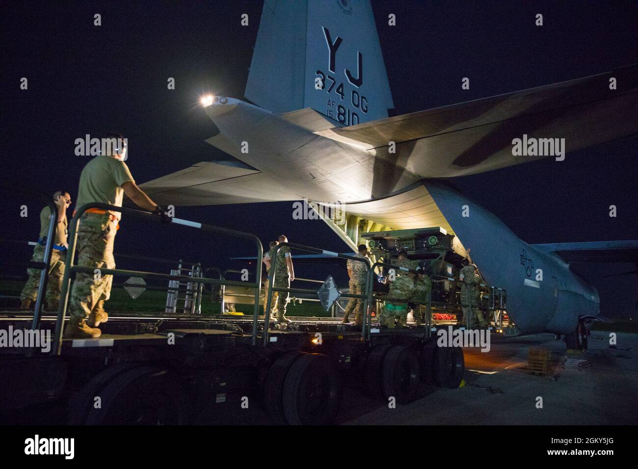 U.S. Marines and Airmen unload an AN/TPS-80 Ground/Air Task Oriented ...