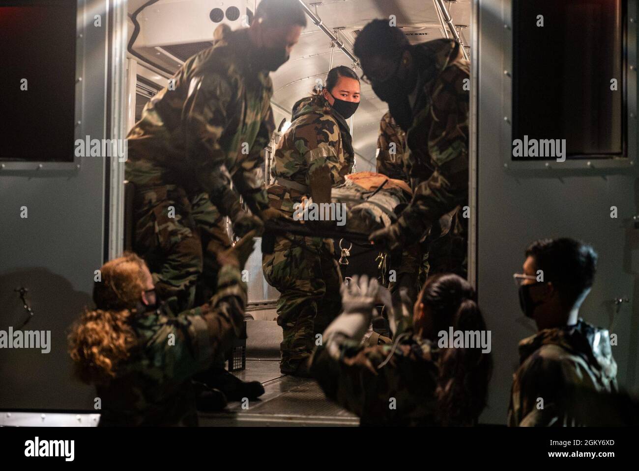 U.S. Airmen assigned to the 8th Medical Group transport a simulated ...