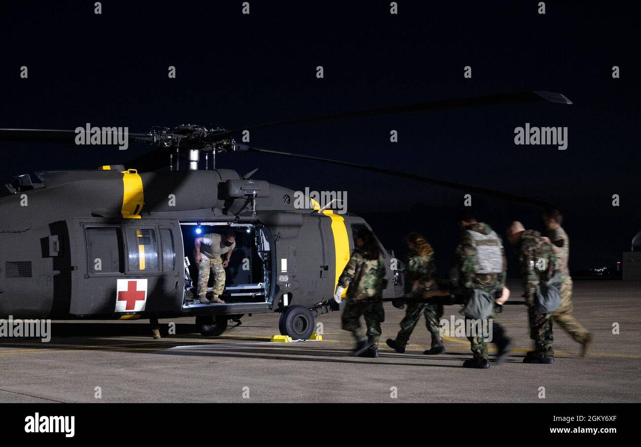 U.S. Airmen assigned to the 8th Medical Group transport a simulated ...