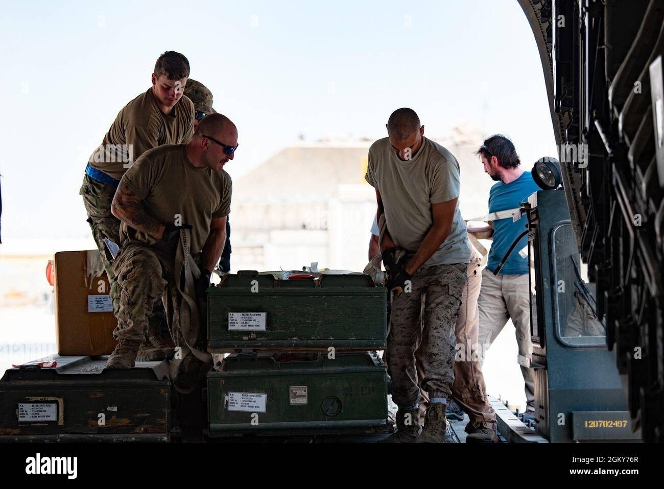 U.S. Airmen and members of the Kuwait Air Force load a case on a Kuwait ...