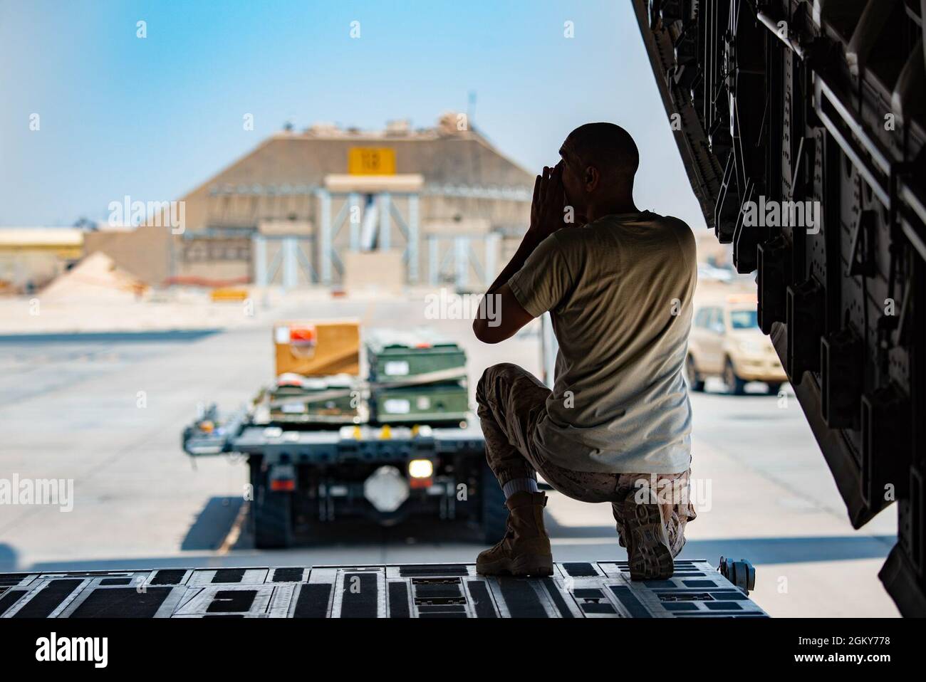 A member of the Kuwait Air Force directs a K-loader to a Kuwait Air ...