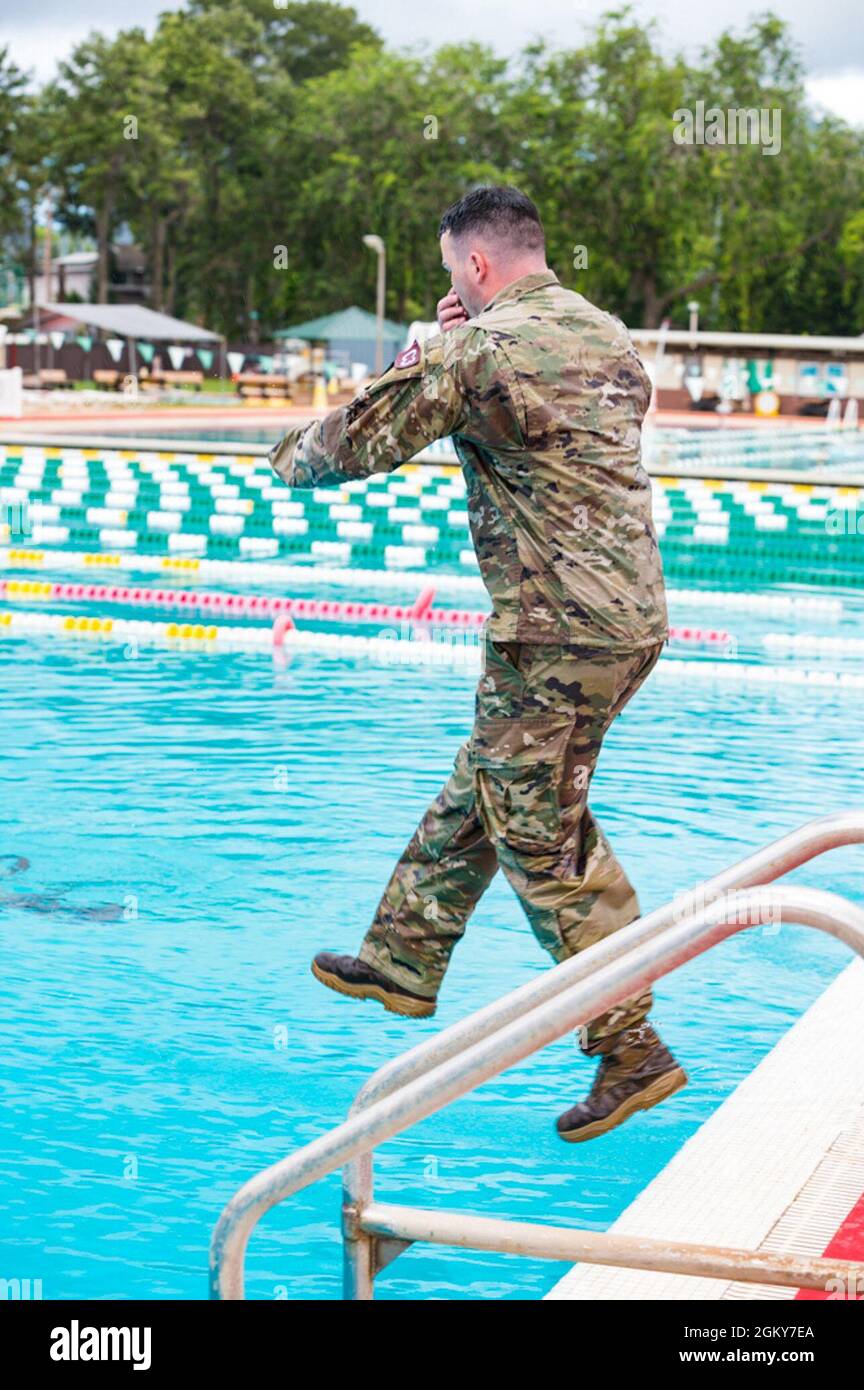 Army Staff Sgt. Edward Nelan competes in the water survival portion of ...