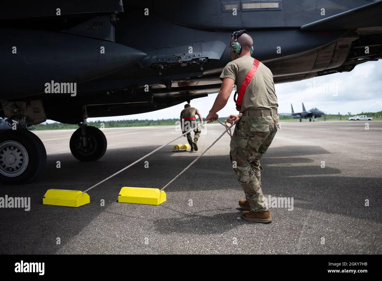 A U.S. Air Force Airman from the 389th Fighter Squadron pulls chocks ...
