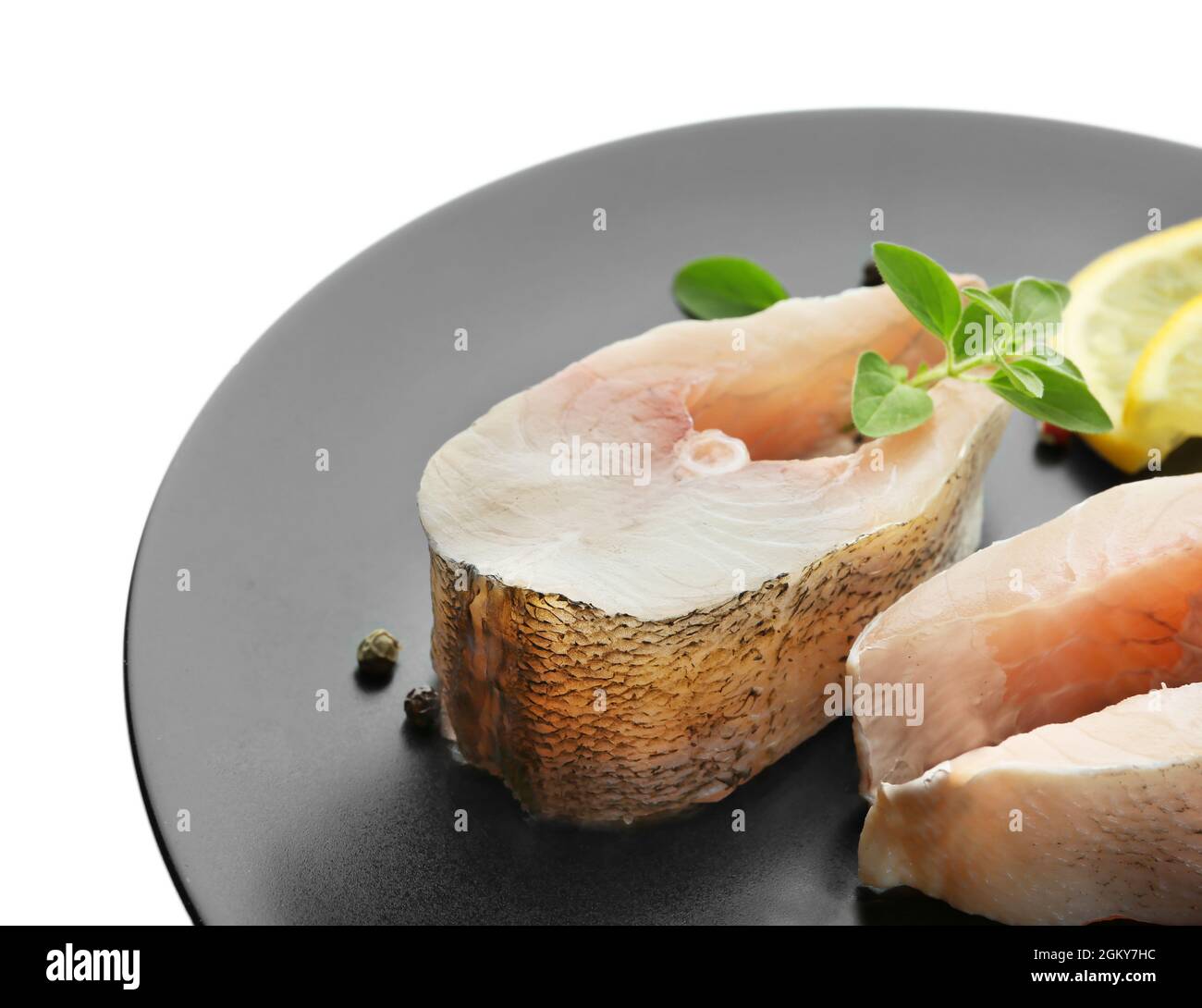 Plate with fresh fish steaks on white background Stock Photo - Alamy