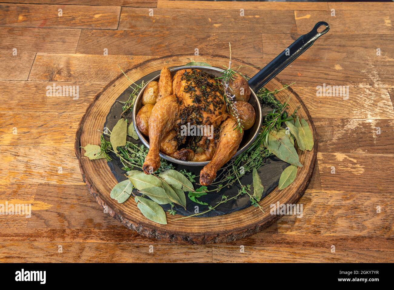Rustic style roast chicken with a lot of rosemary and a garnish of ...