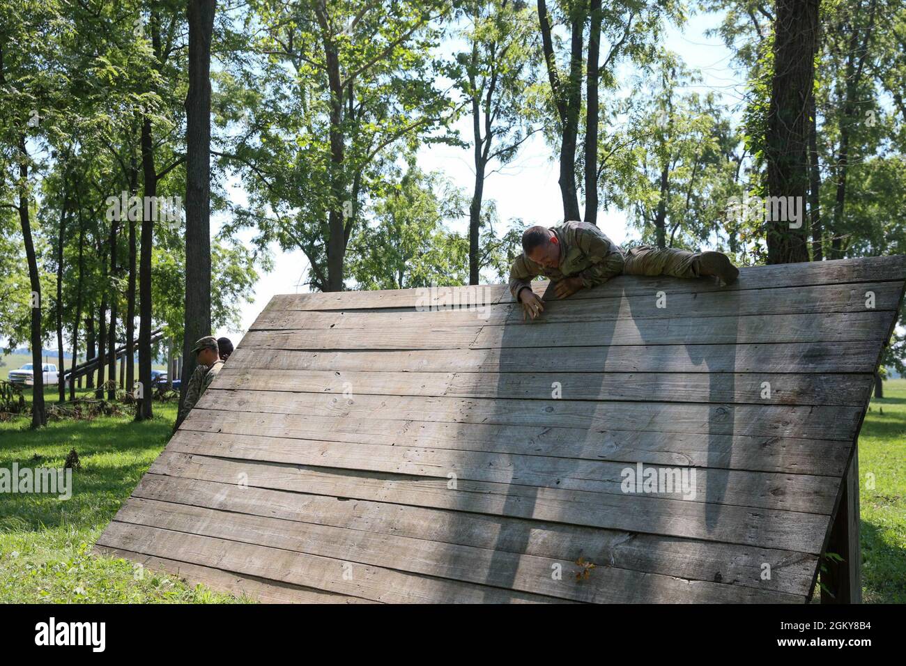 Staff Sgt. Devin Fink clears a wooden wall as part of the obstacle course at the Army Materiel ...