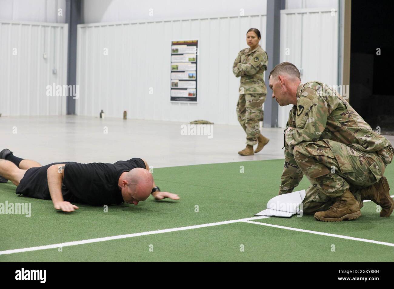 Sgt. 1st Class Tyler Price completes the hand release push-up portion ...