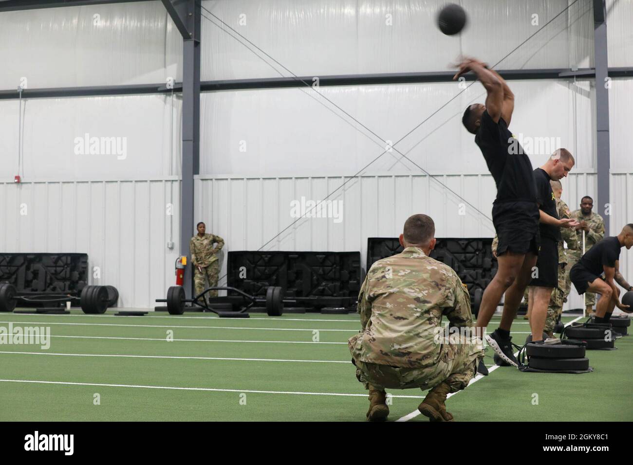 Sgt. 1st Class Jonathan Tyndall completes the standing power throw ...