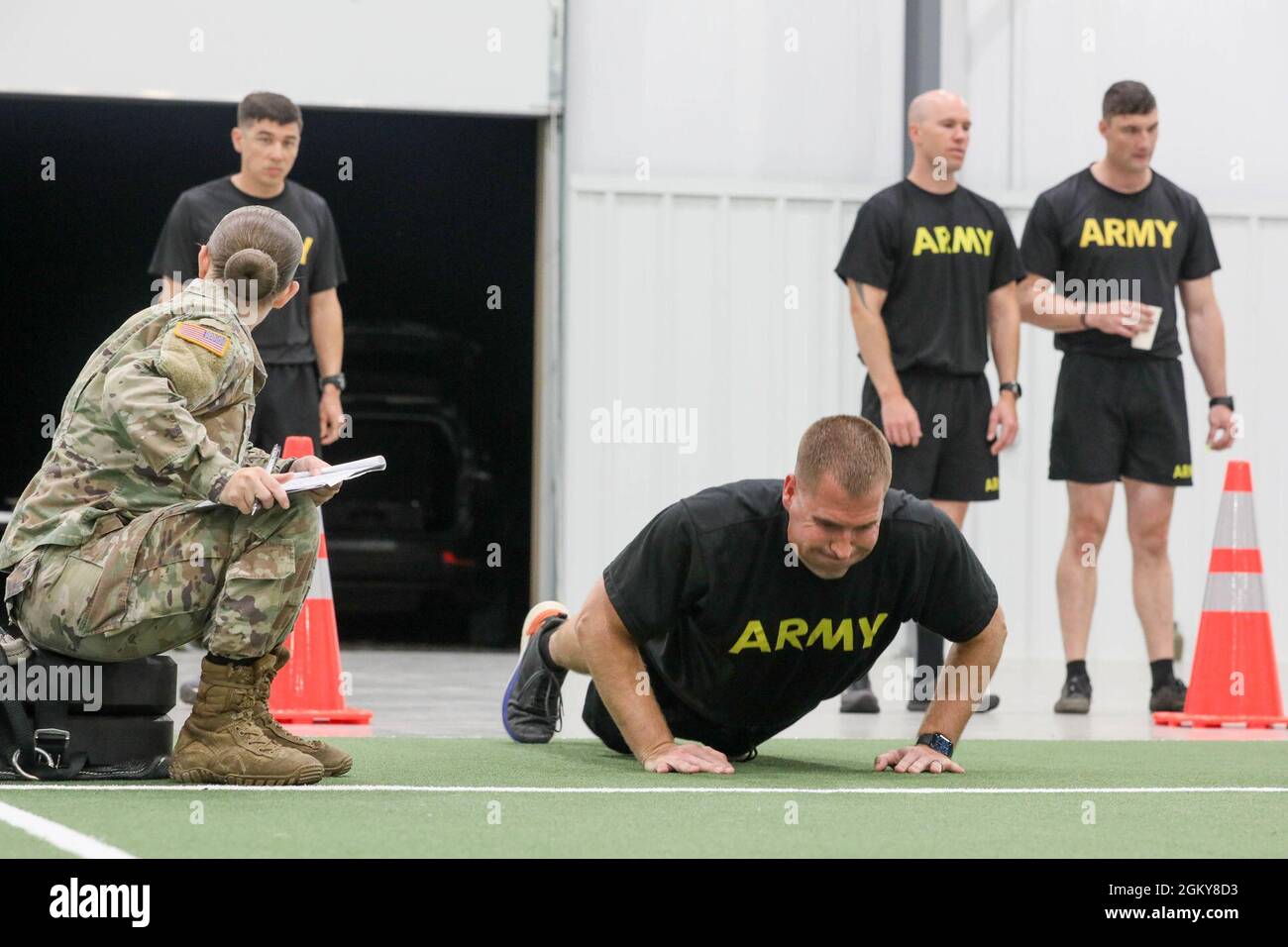 Staff Sgt. Douglass Staub completes the hand release push-up portion of ...