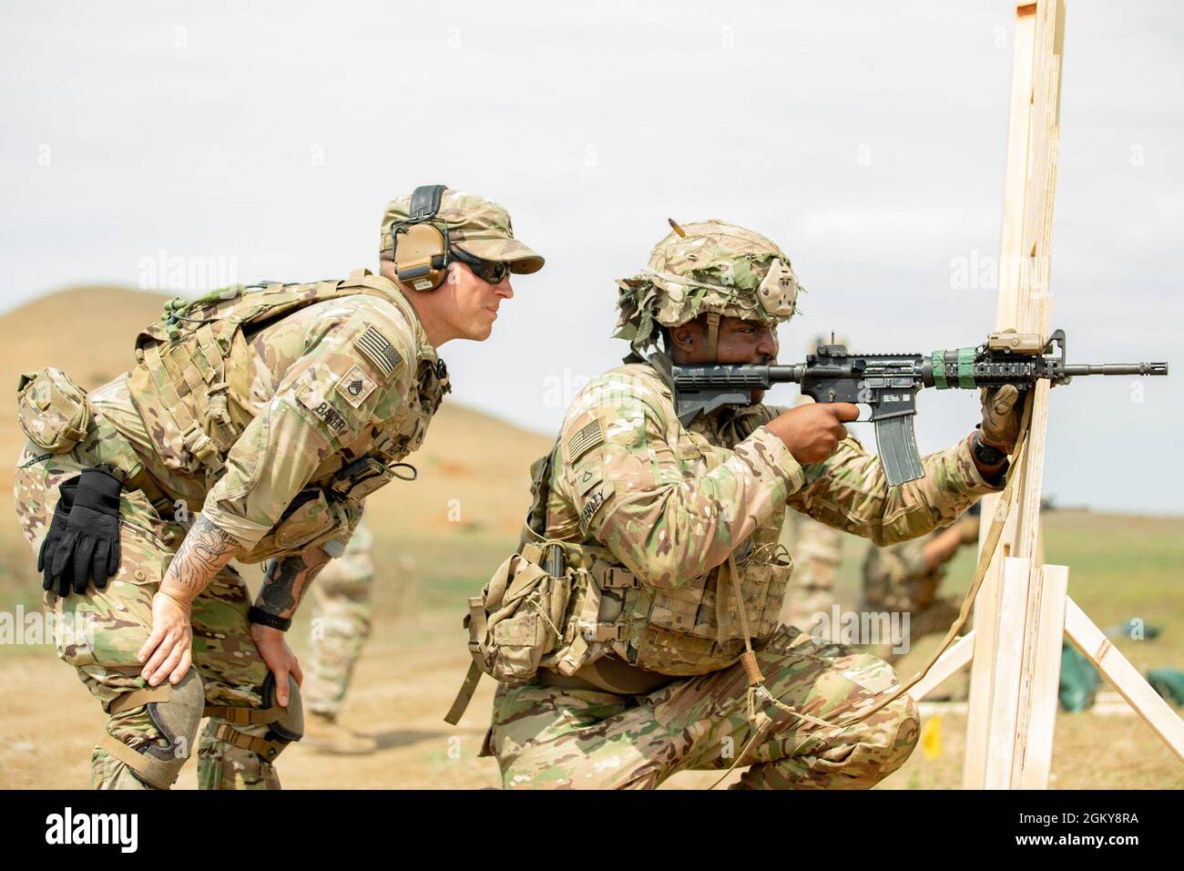 U.S. Army Staff Sgt. Kenneth Baker, a section leader, coaches Pfc ...