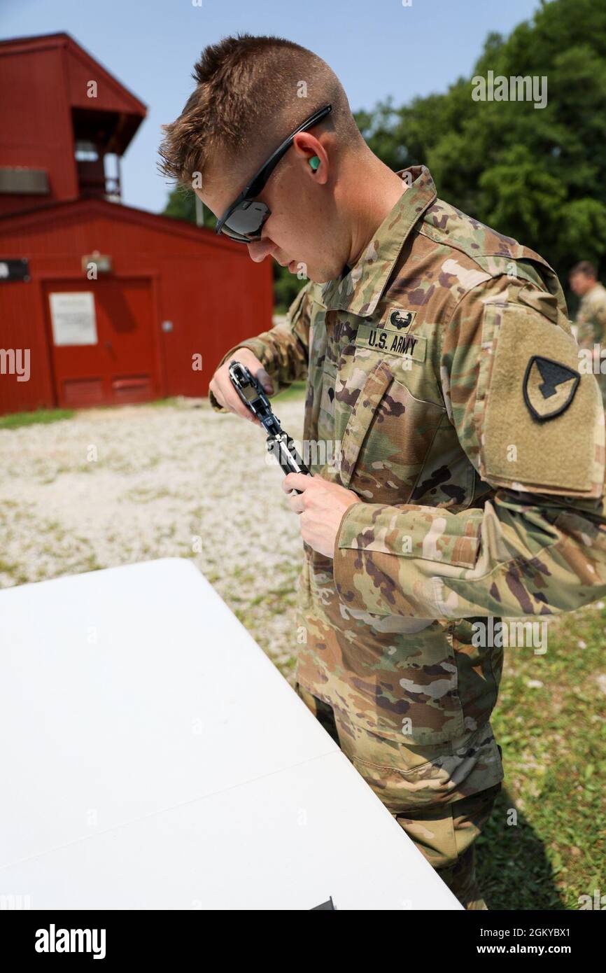 Spc. Alexander Haydon disassembles and reassembles the M9 pistol during ...
