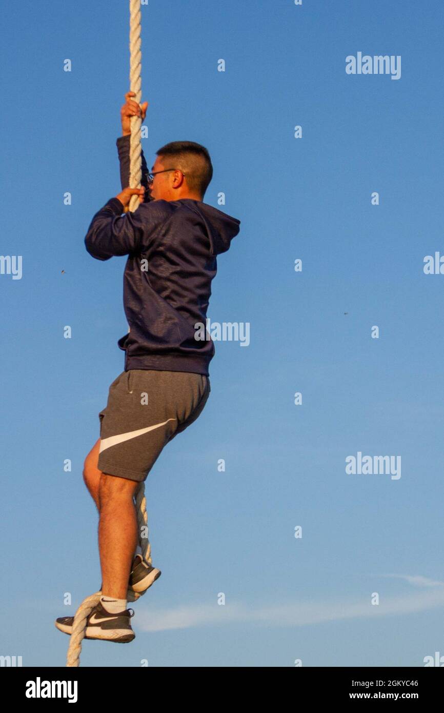 A newly assigned soldier to the 10th Special Forces (Airborne) climbs a ...