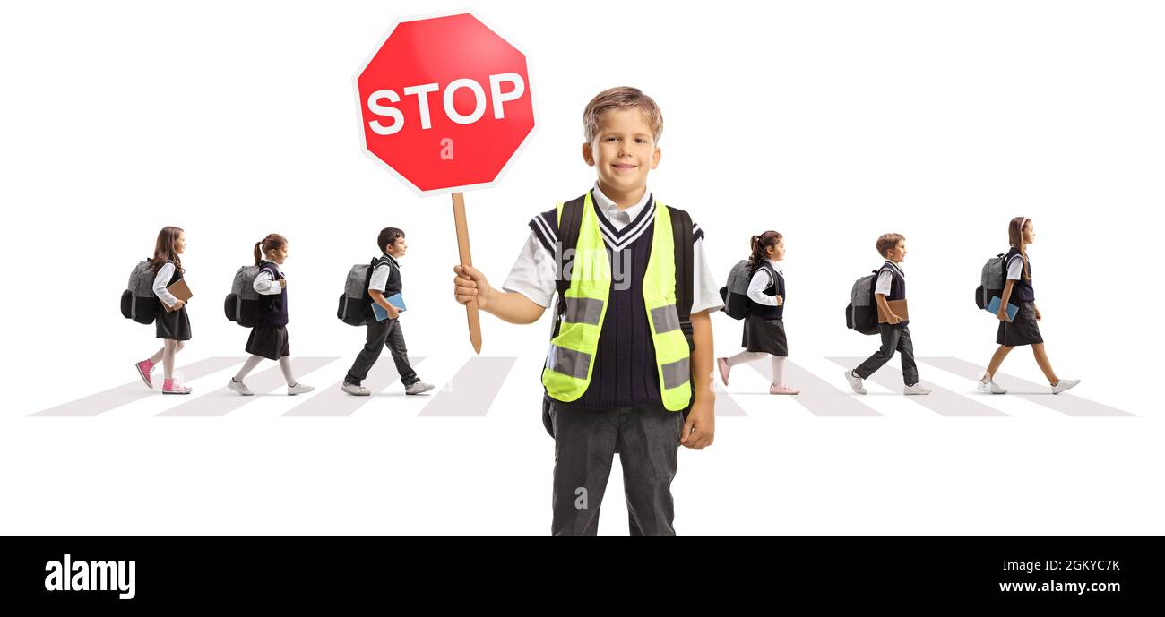 Schoolboy in a reflective safety vest holding a stop sign and children ...