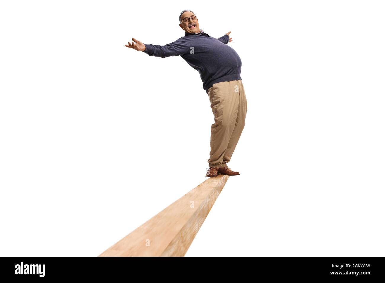 Full length shot of a funny mature man standing on a wooden beam and ...