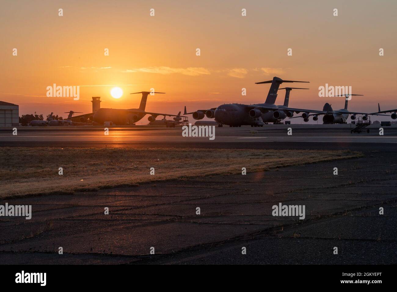 Heavy-lift aircraft sit on the flight line during sunrise July 28, 2021 ...