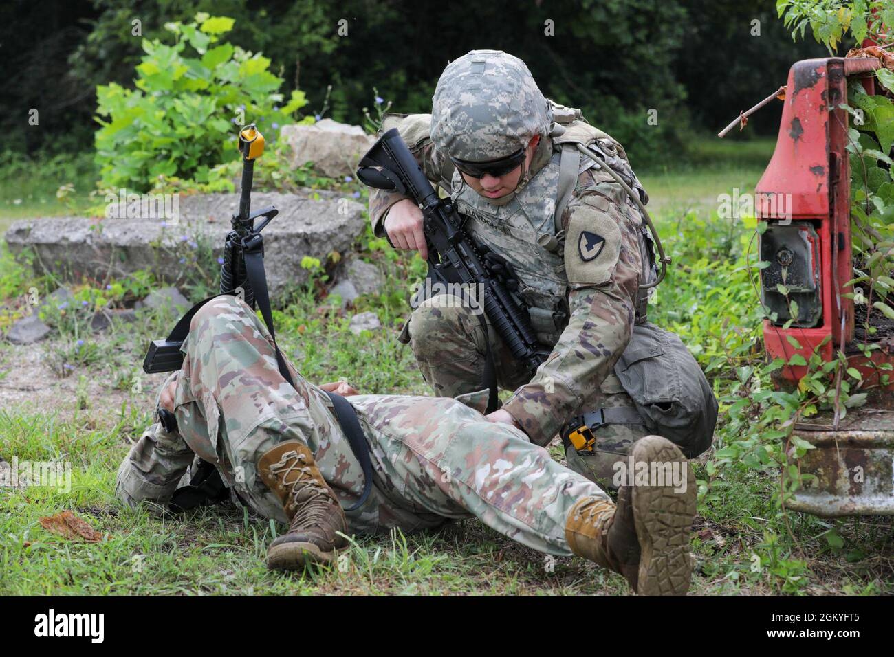 Spc. Alexander Haydon (right) aides his battle buddy during a mock ...
