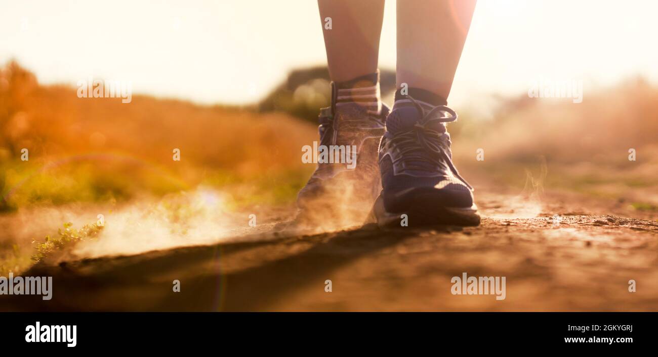 Female athletic legs and dust from the trail close up Stock Photo - Alamy