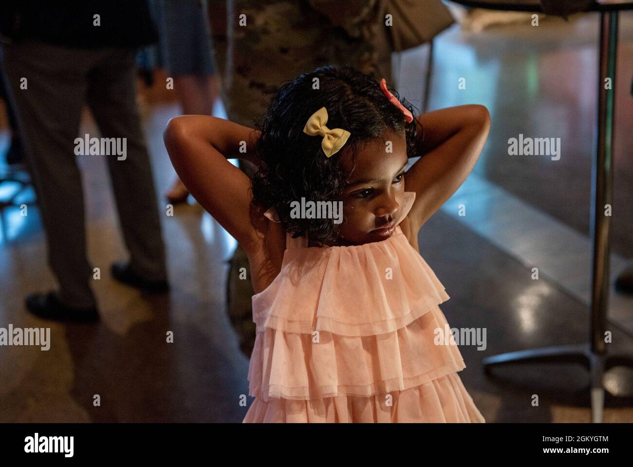 A young girl stretches while attending a farewell reception for Col ...