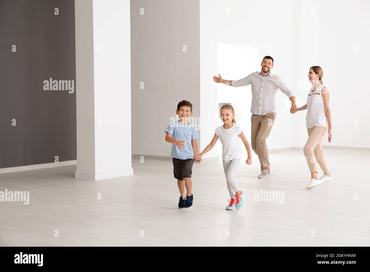 Happy family in new empty flat Stock Photo - Alamy