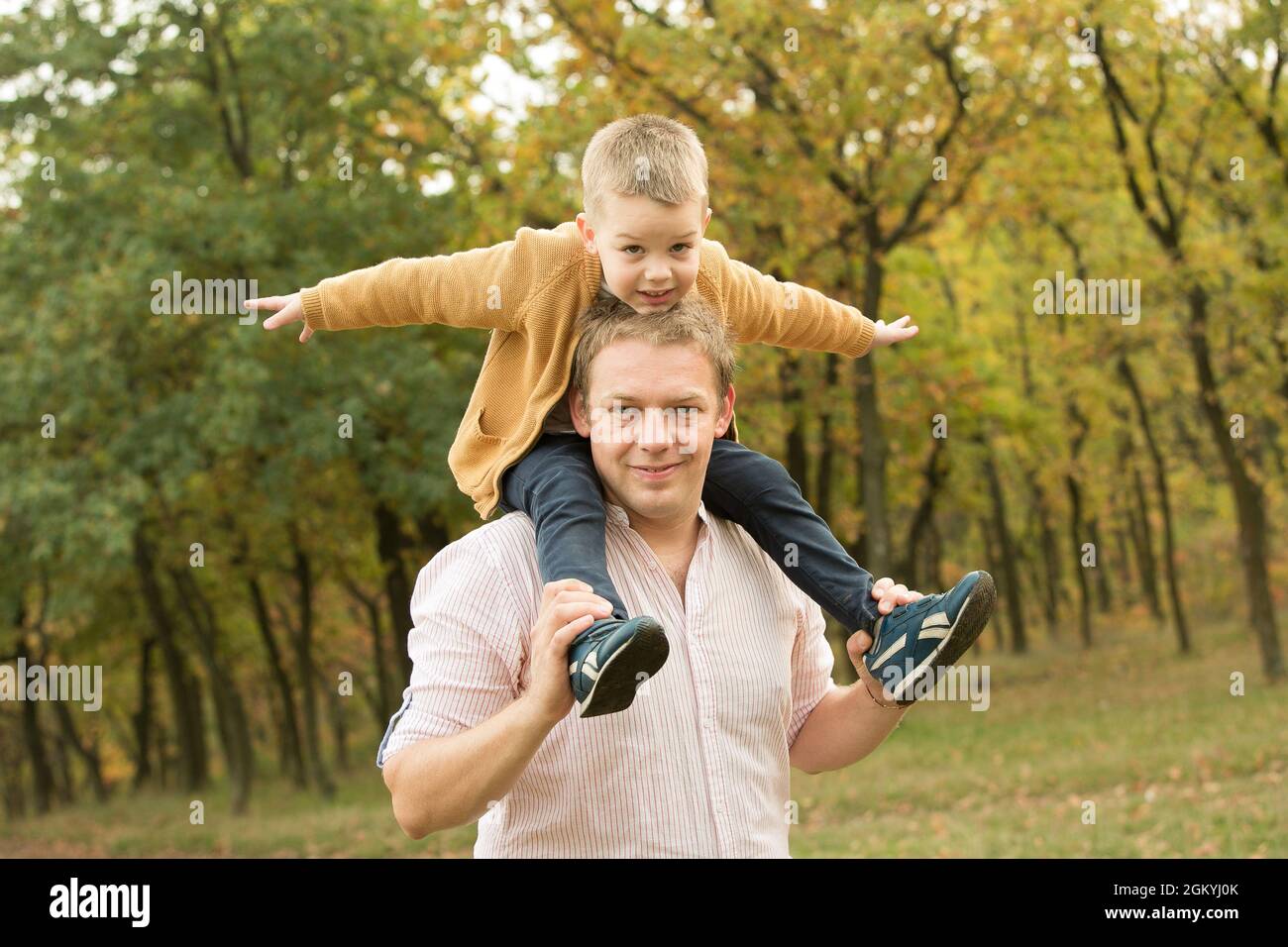 Fall. Close-up of happy and laughing dad and son on the background of ...