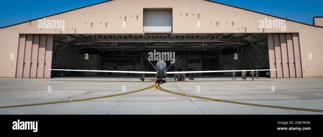 An EQ-4 Block-20 Global Hawk is positioned outside a hangar after ...