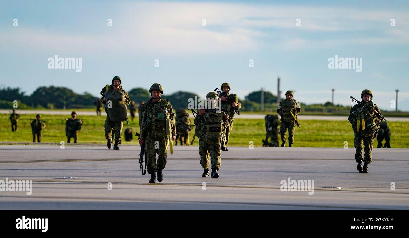 Soldiers from the Japan Ground Self-Defense Force ruck toward a ...
