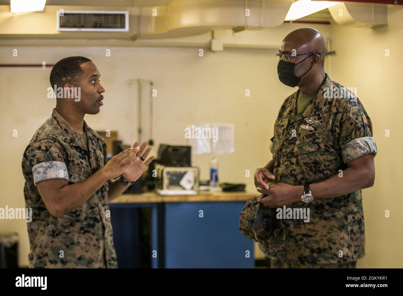 U.S. Navy HM1 Daniel St. Louis, left, leading petty officer with the ...