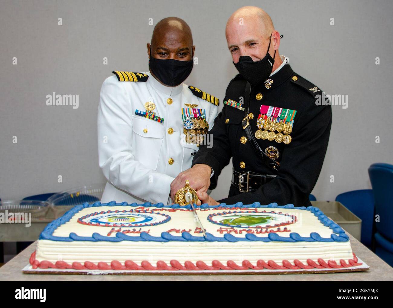 Navy Capt. Nathan King (left) and Marine Corps Col Jesse Sjoberg cut ...
