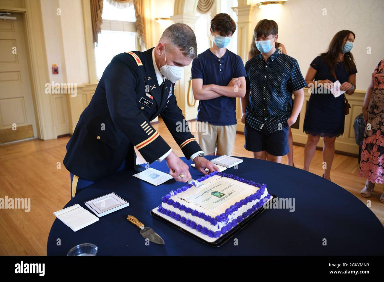 U.S. Army Col. William Kirby, commander, Joint Planning Support Element, makes the first cut of ...