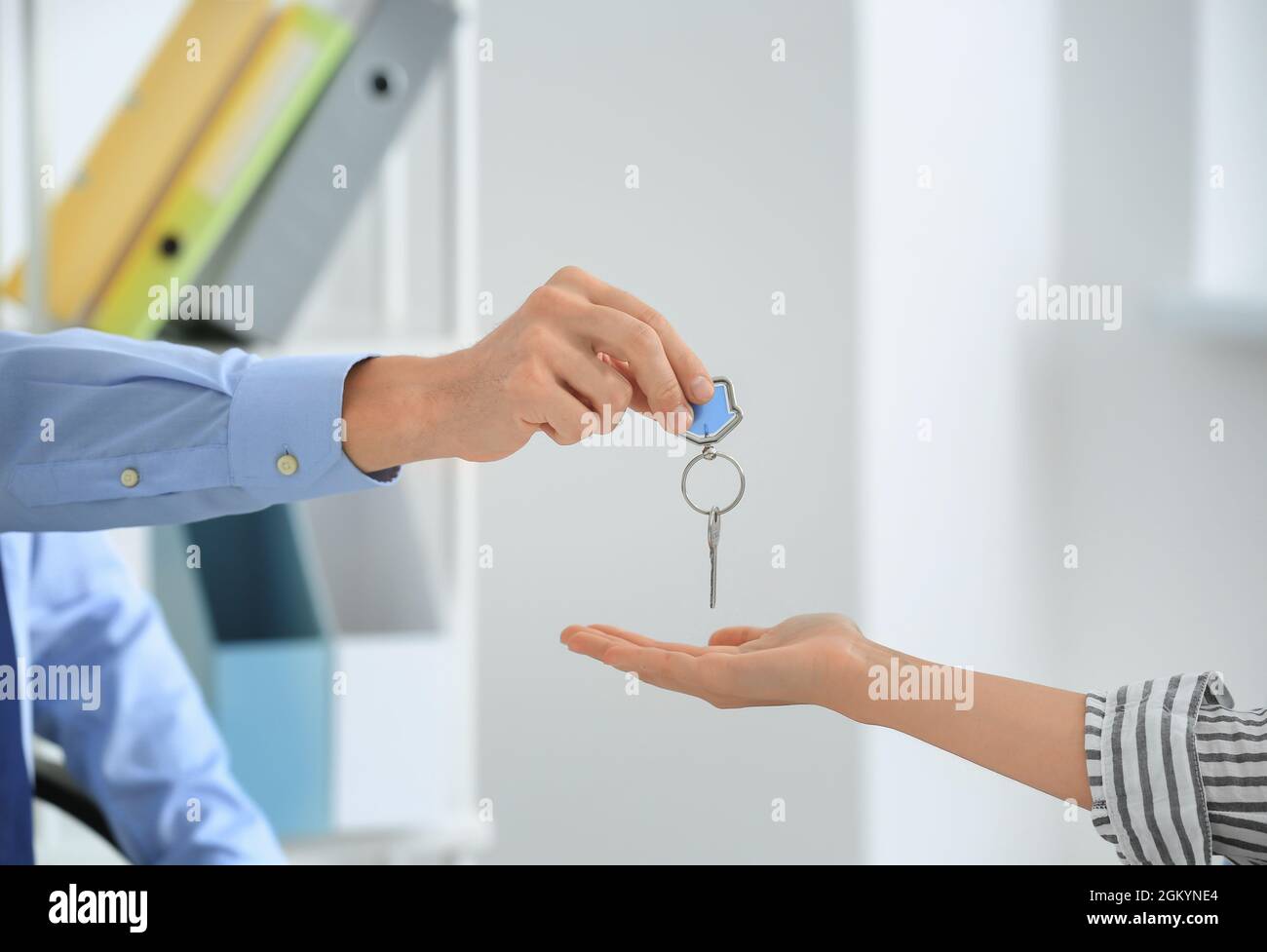 Hand of real estate broker giving customer key from new flat Stock ...