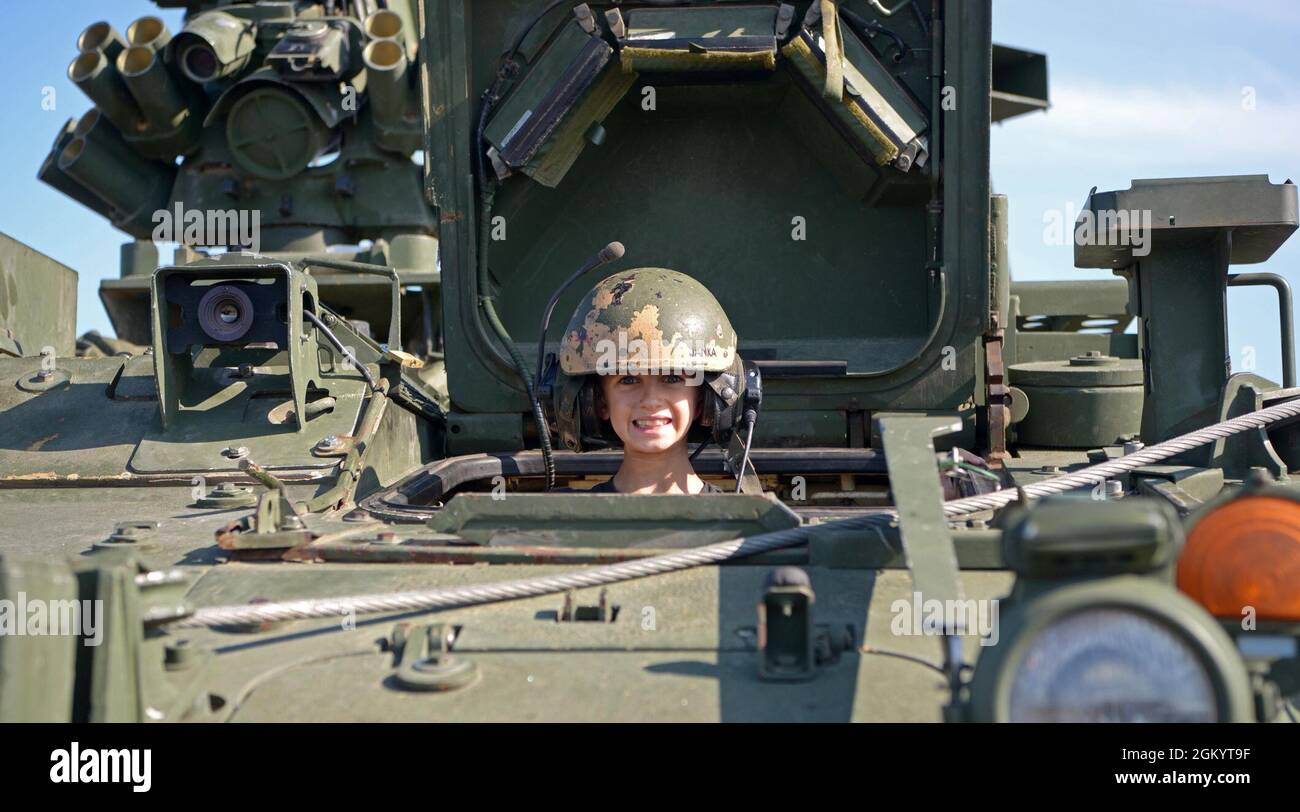 A child smiles for a photo in a U.S. Army vehicle static display during ...