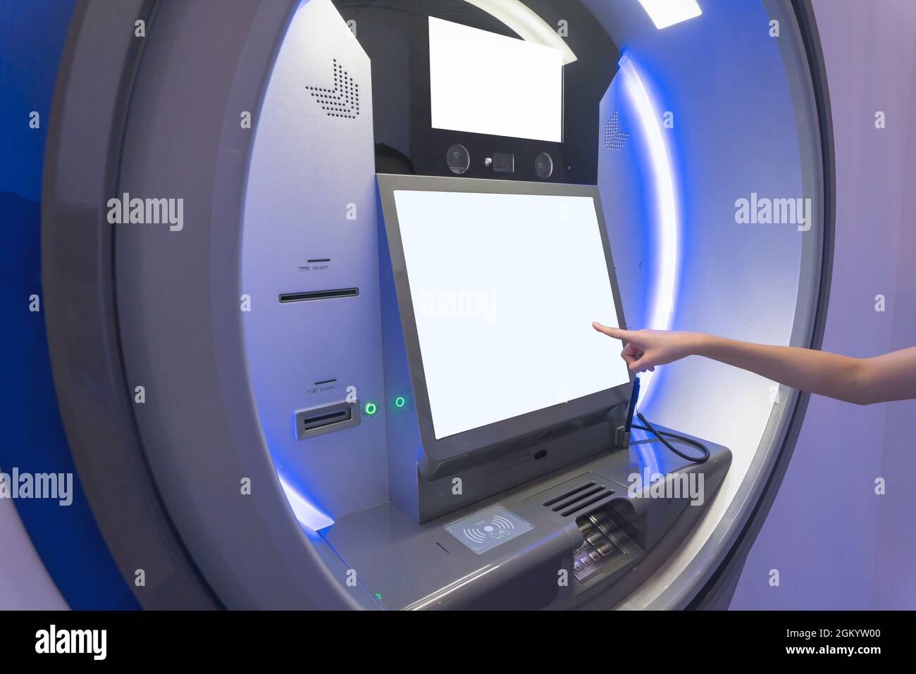 Hand touching the blank screen of a futuristic Automated Teller Machine ...