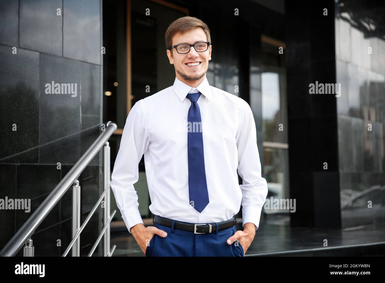 Attractive young man in formal wear on city street Stock Photo - Alamy