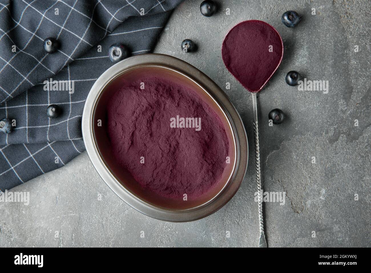 Acai powder in metal bowl and spoon on grey background Stock Photo - Alamy