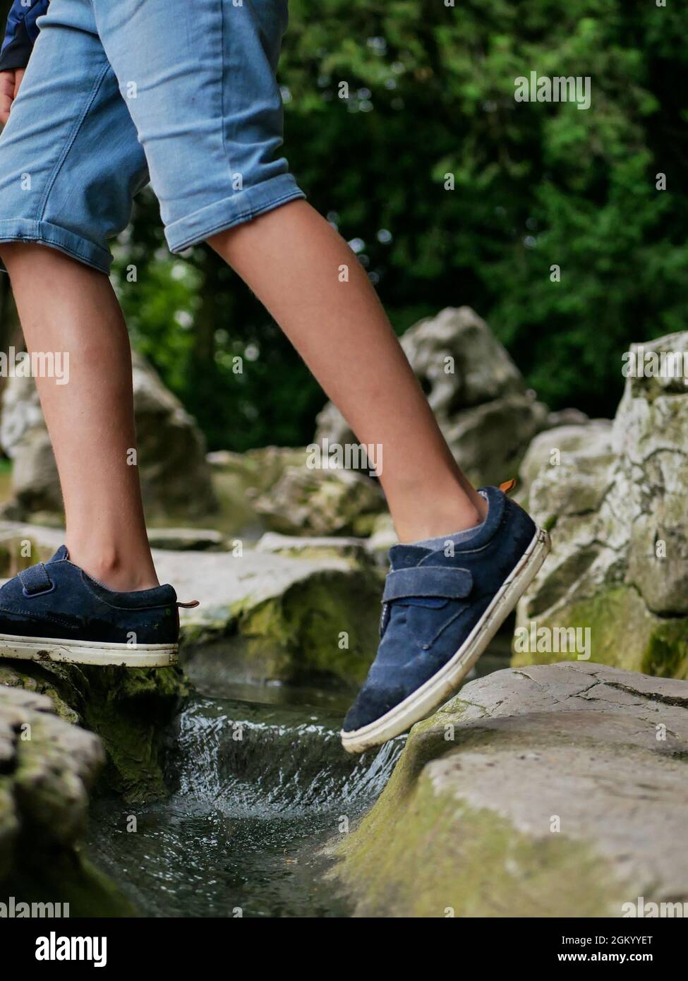 Child crossing a stream hi-res stock photography and images - Alamy