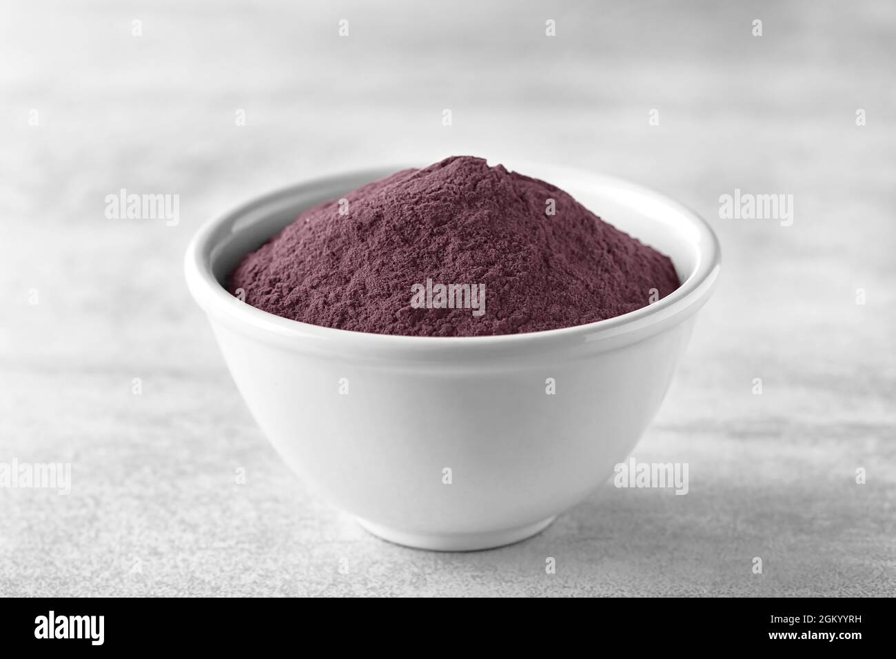 Bowl with acai powder on table Stock Photo - Alamy