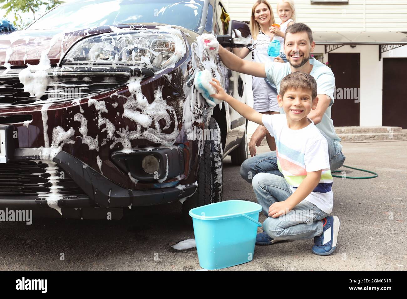 Boy helping father to wash car hi-res stock photography and images - Alamy