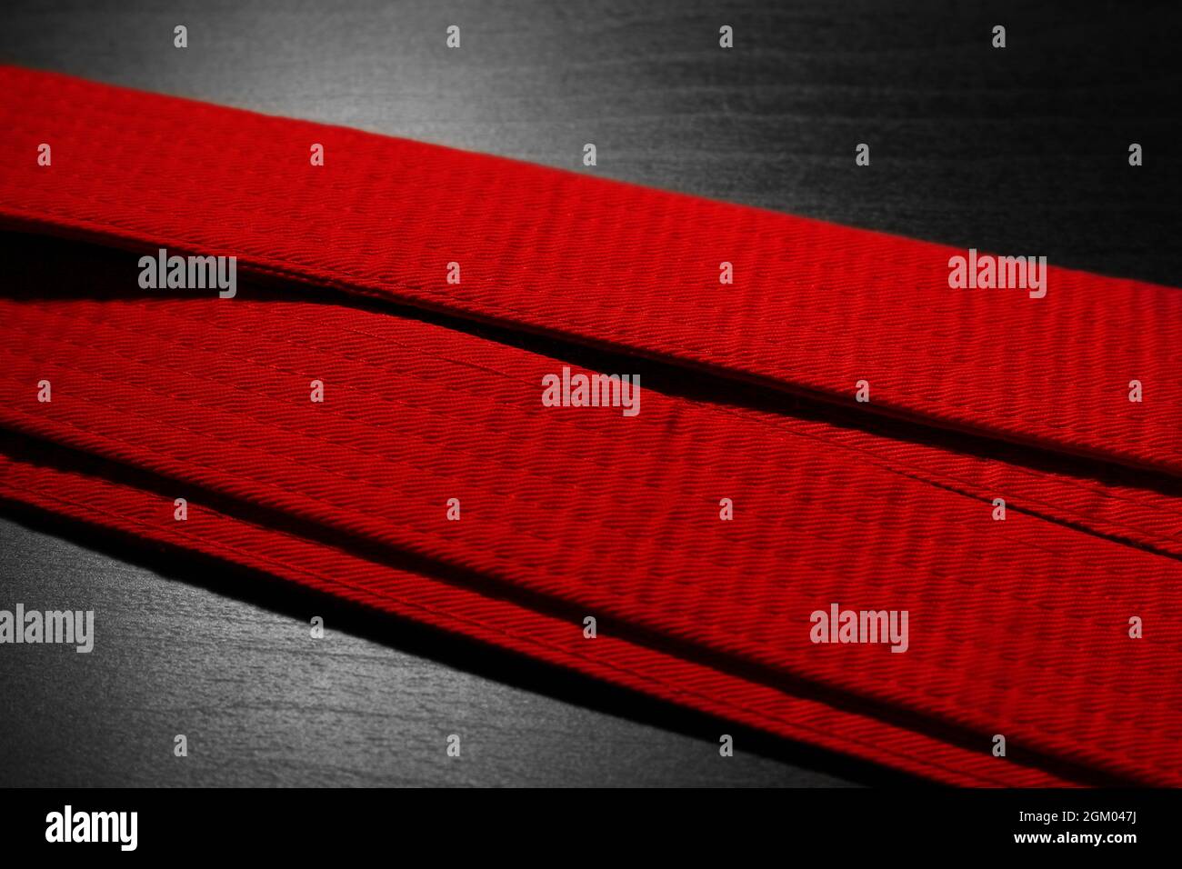 Red karate belt on dark background Stock Photo - Alamy
