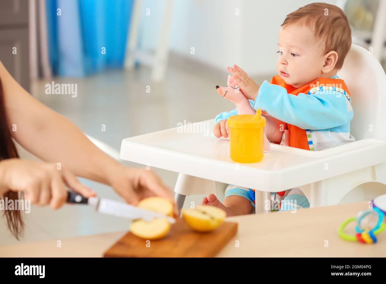 Mother and cute little baby in kitchen Stock Photo - Alamy