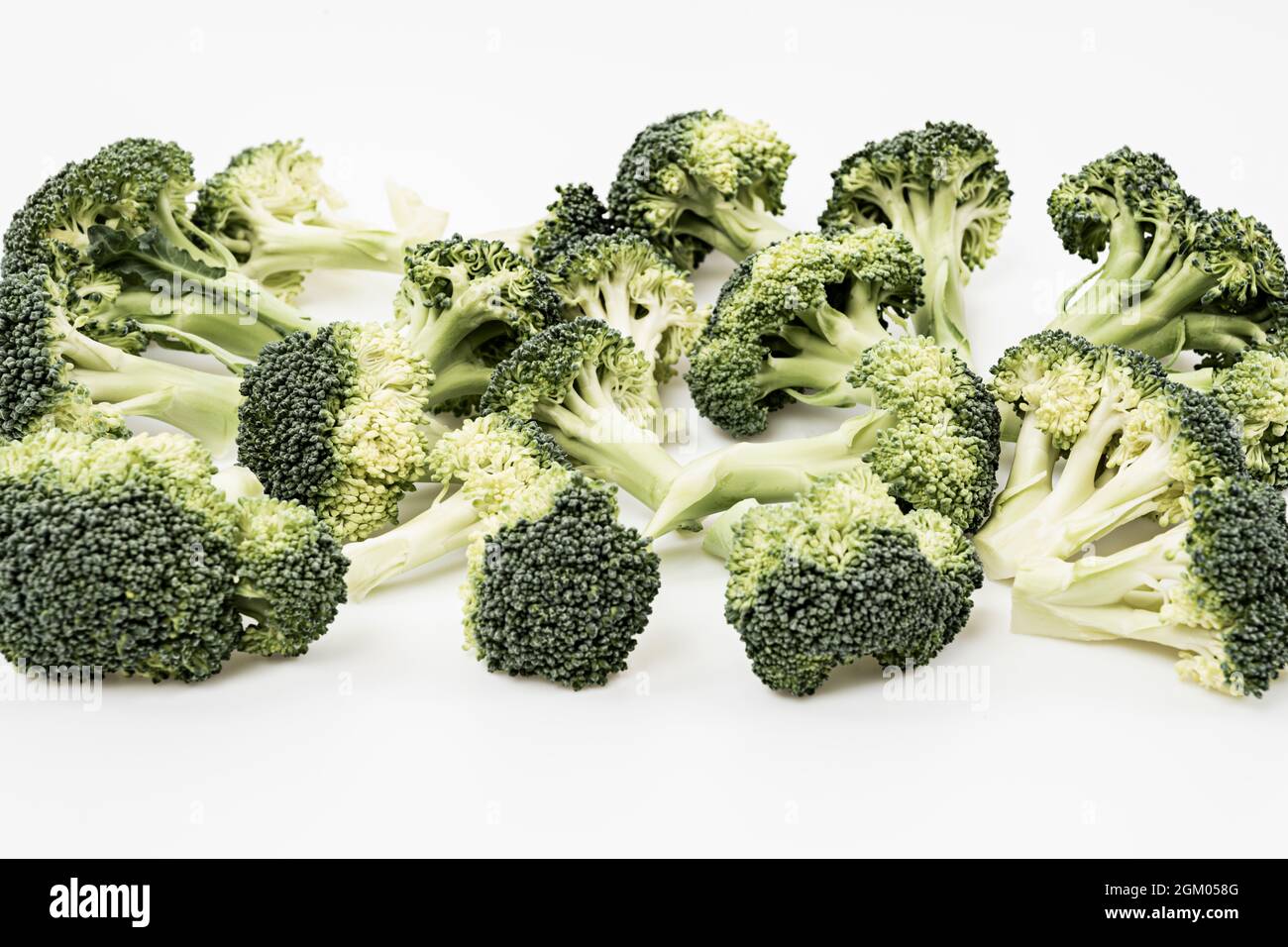 raw green broccoli branches on white background Stock Photo - Alamy