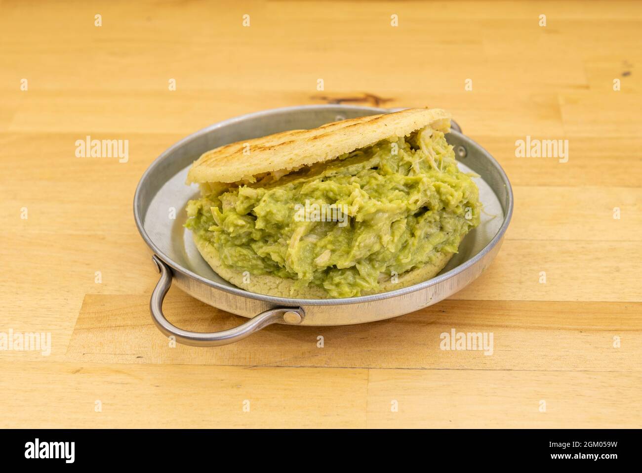 Venezuelan queen pepiada corn arepa well filled with ingredients on an ...
