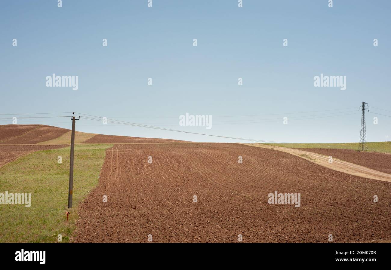 rows of soil before planting on slope. Furrows row pattern in a plowed ...